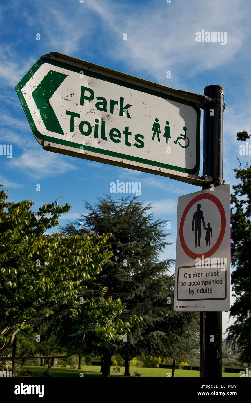 Close up of sign which says park toilets with the symbols for Men women ...