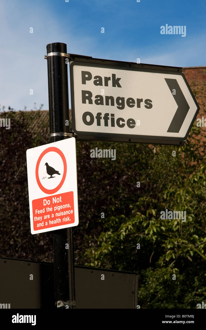 Sign showing directions to the park rangers office another which warns ...