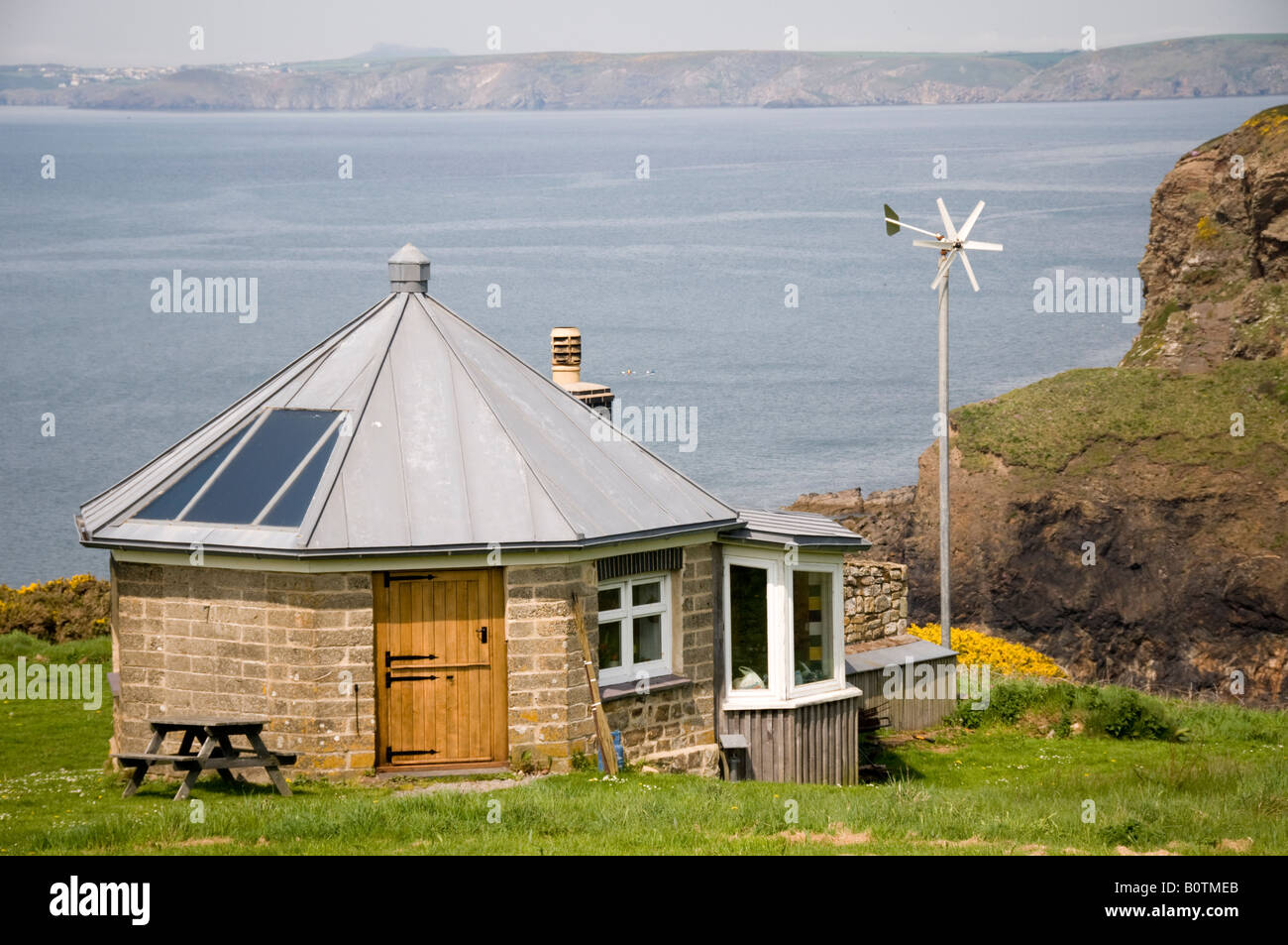 Wind turbine producing electricity for a small round house part of the ...
