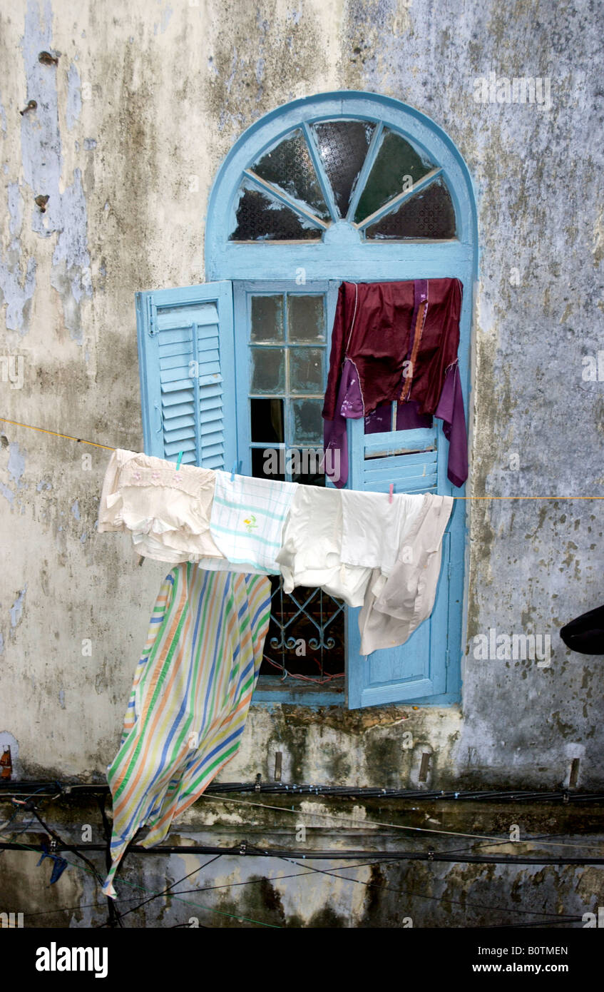 washing hanging from blue window Stock Photo - Alamy
