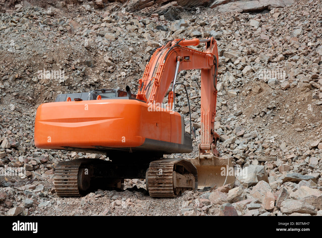 Red excavator in a stone pit Stock Photo - Alamy