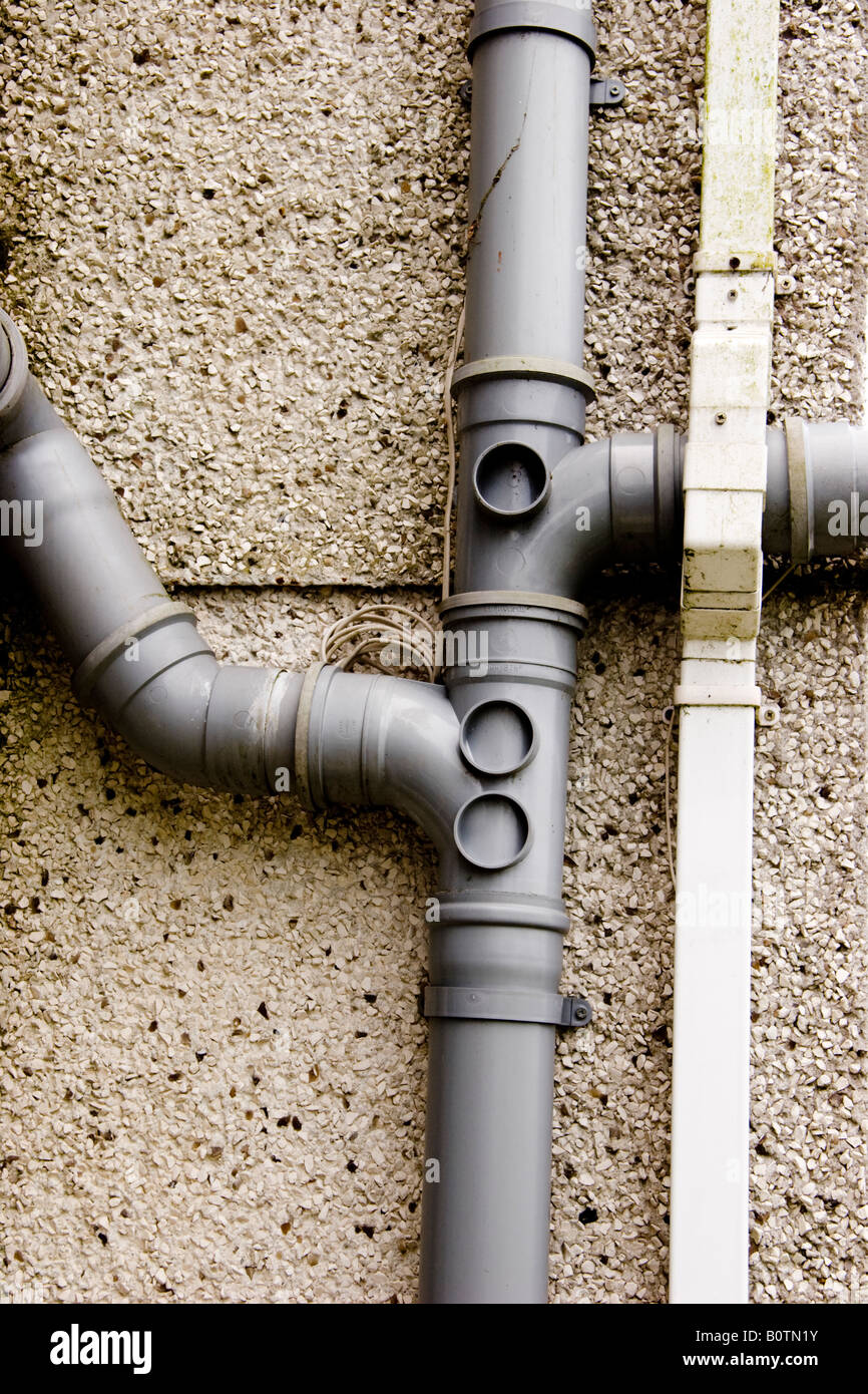 Drain pipes fixed to a wall Stock Photo - Alamy