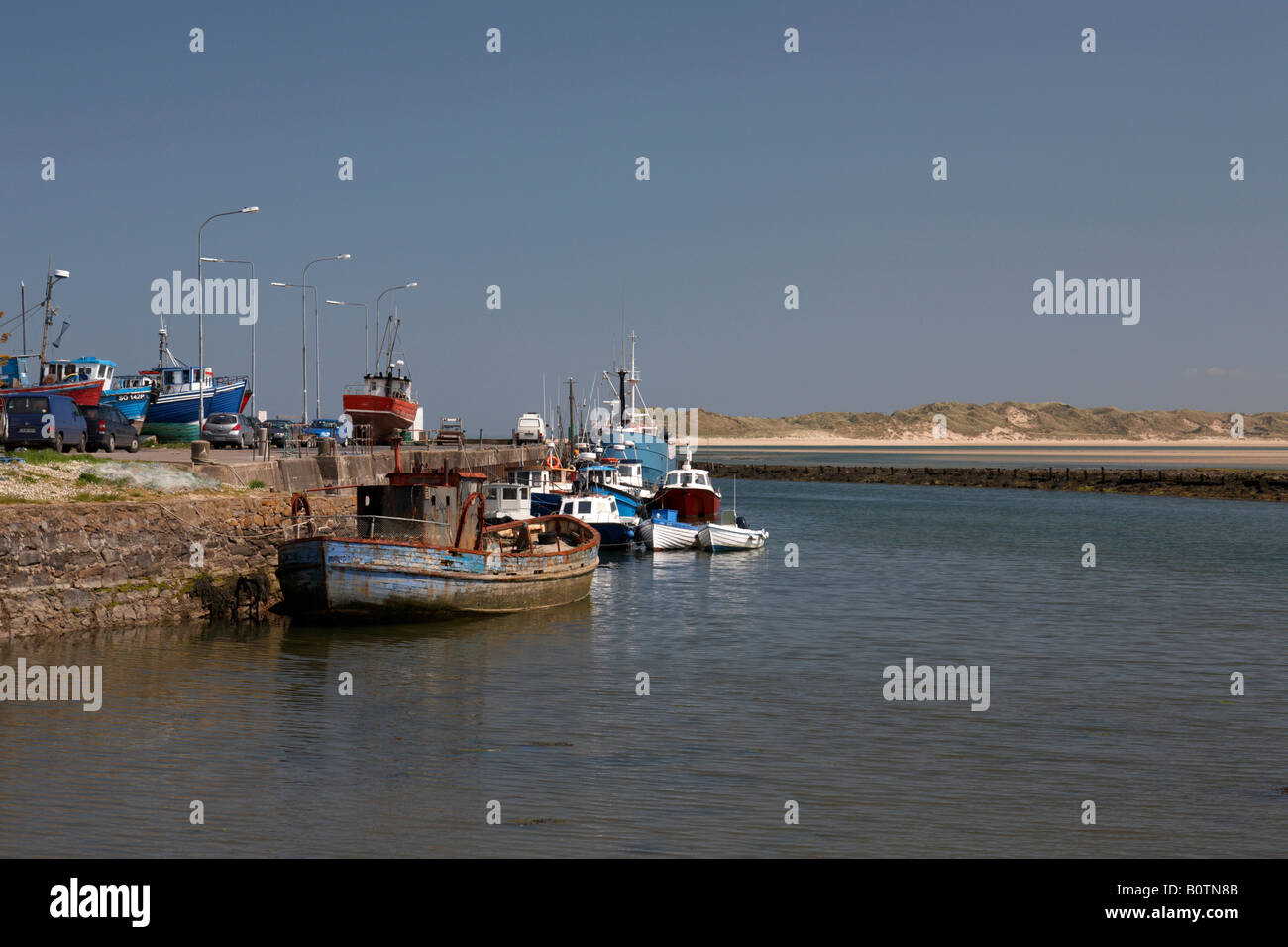 fishing boats at the working killala pier with killala bay in the ...