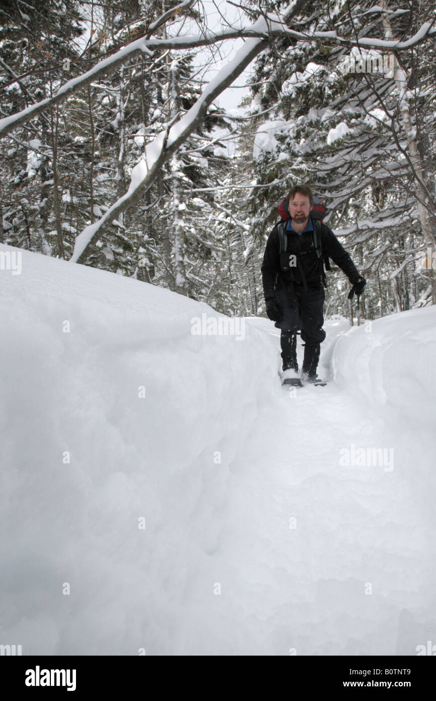 Hikers snowshoeing on the Hancock Notch Trail during the winter months ...