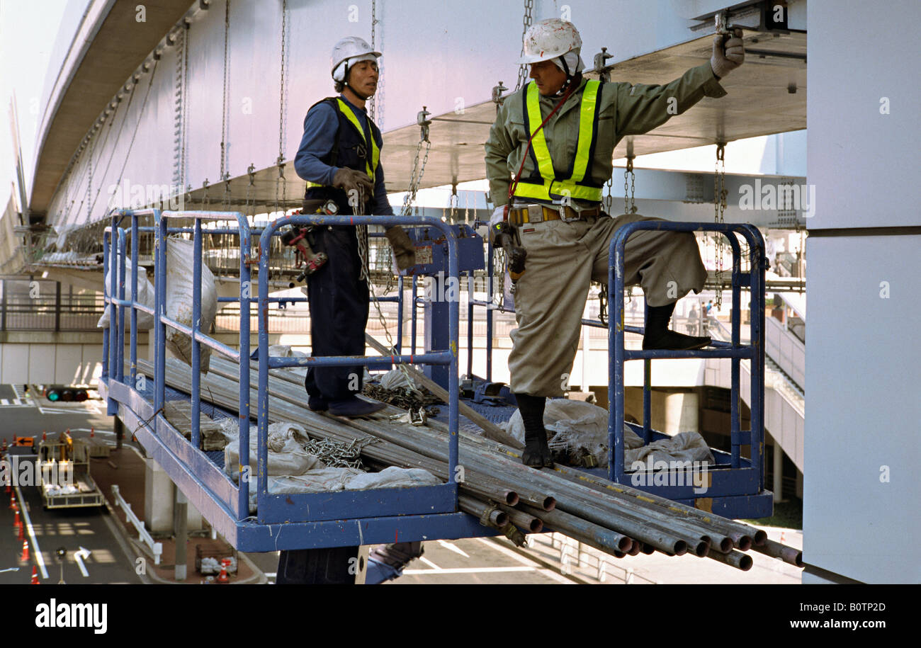 Feb 20, 2004 - Construction workers on an elevated platform underneath ...