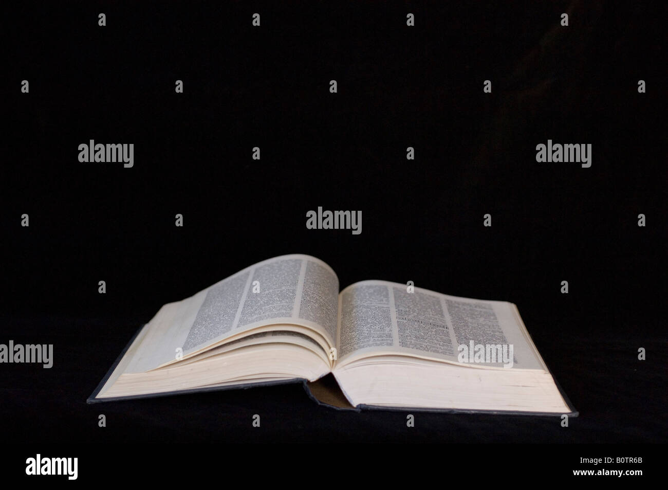 Open book on a black background Stock Photo - Alamy