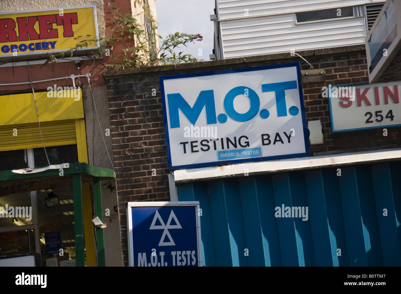 Colourful signs, one reads MOT testing Bay Stock Photo - Alamy