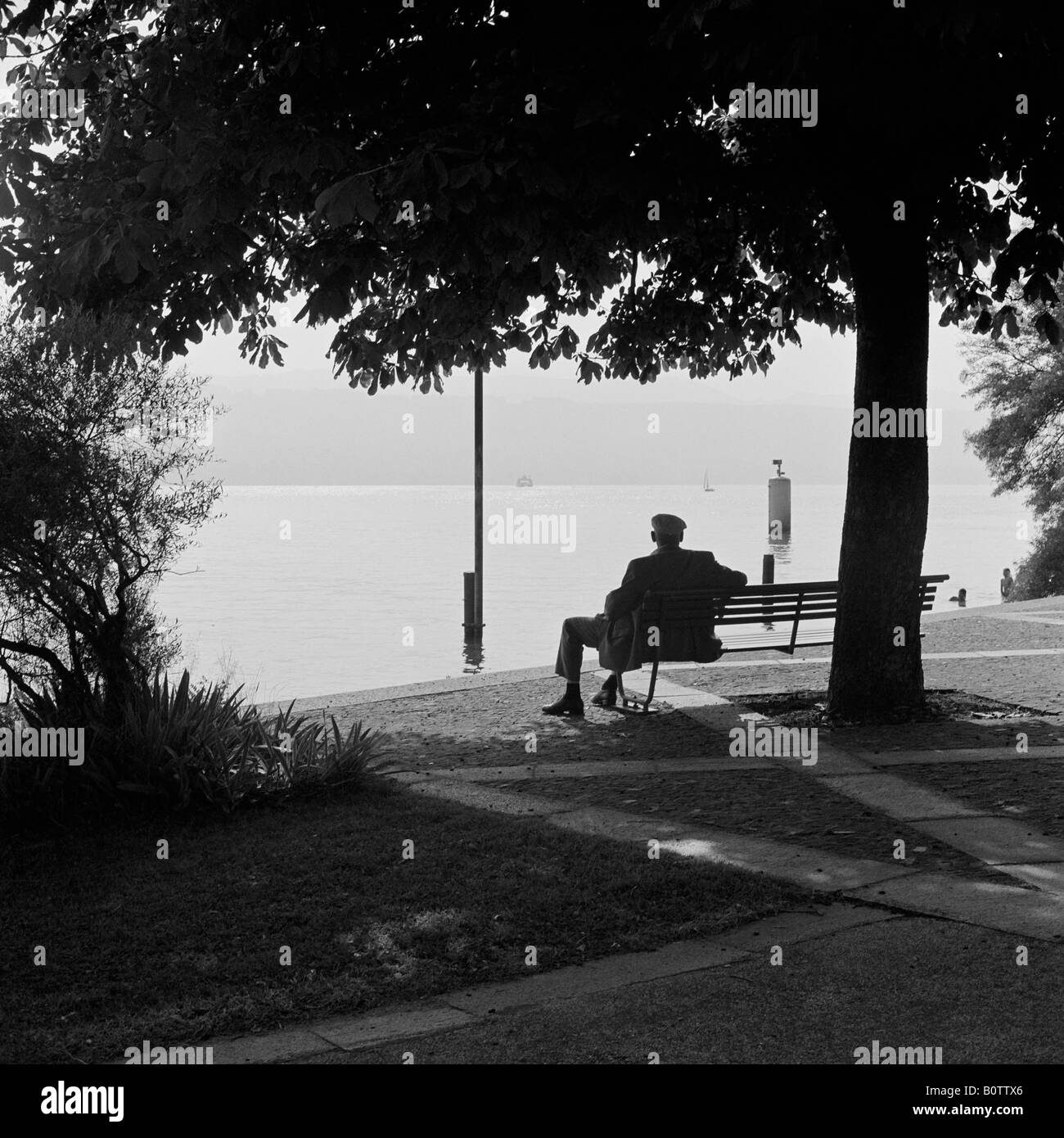 Sitting man beside Black and White Stock Photos & Images - Alamy