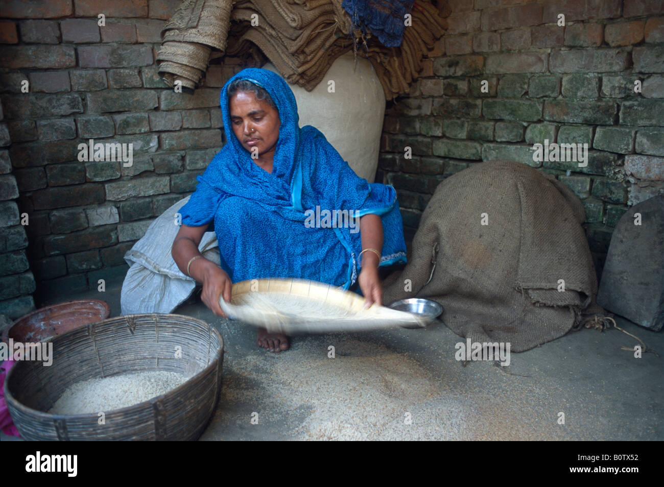 sifting rice for cooking Bangladesh Stock Photo - Alamy