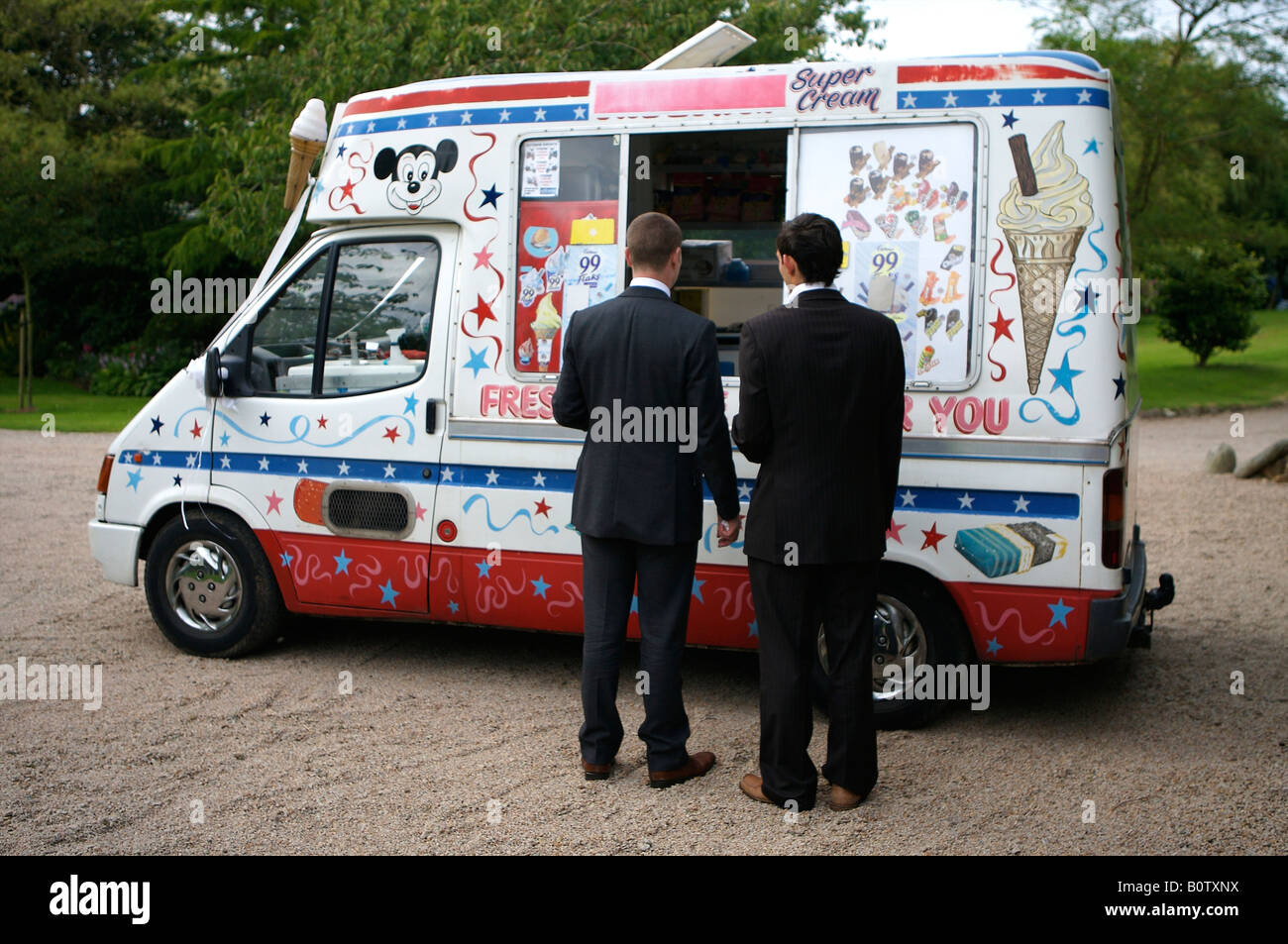 Two men in suits queueing at an ice cream van Stock Photo - Alamy