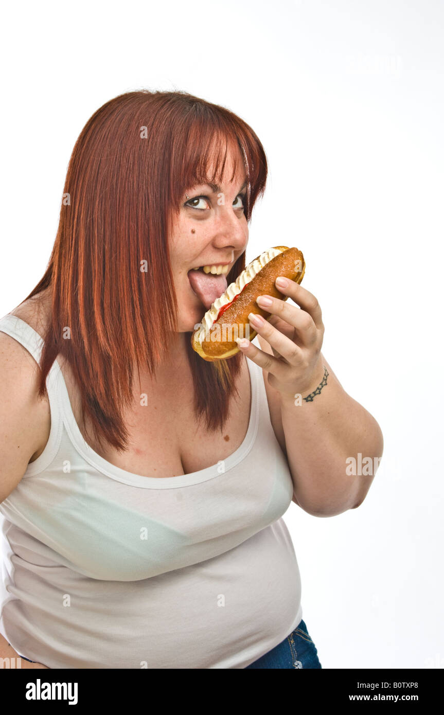 overweight young woman licking the filling out of a fattening jam and ...
