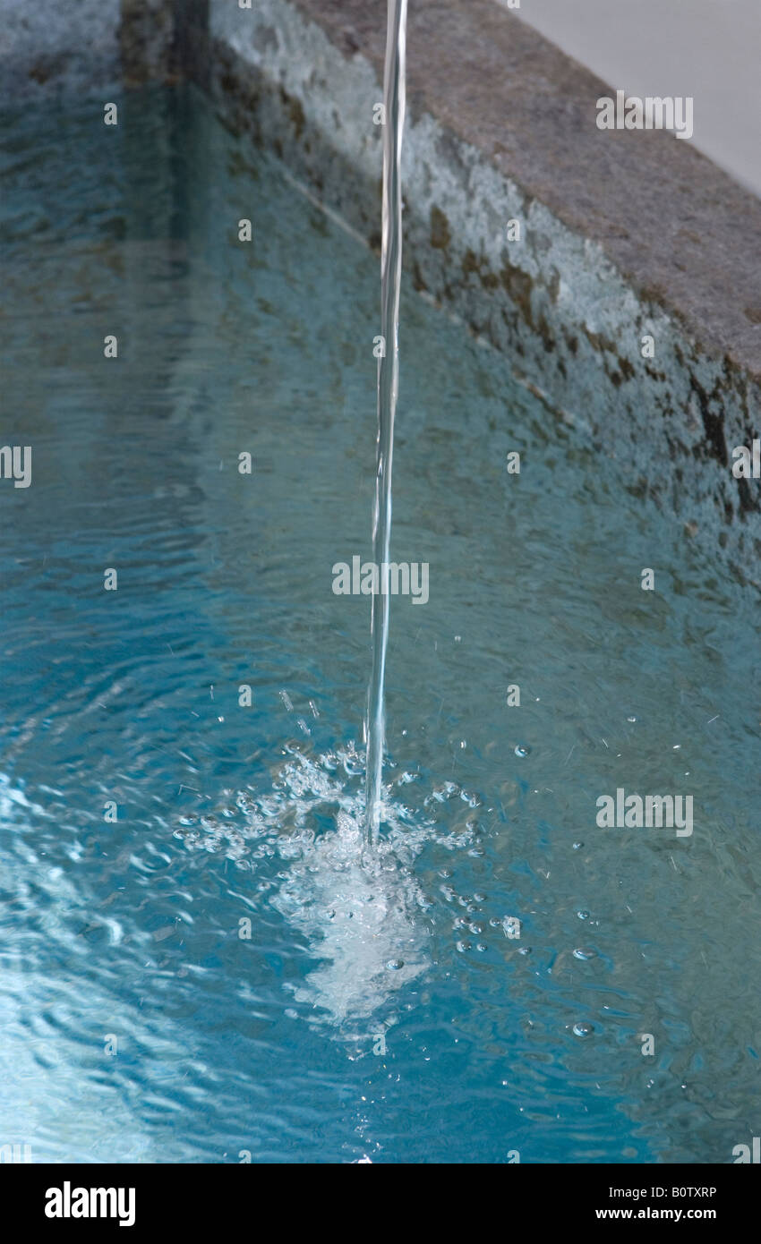 string of water pouring from small fountain pipe Stock Photo - Alamy