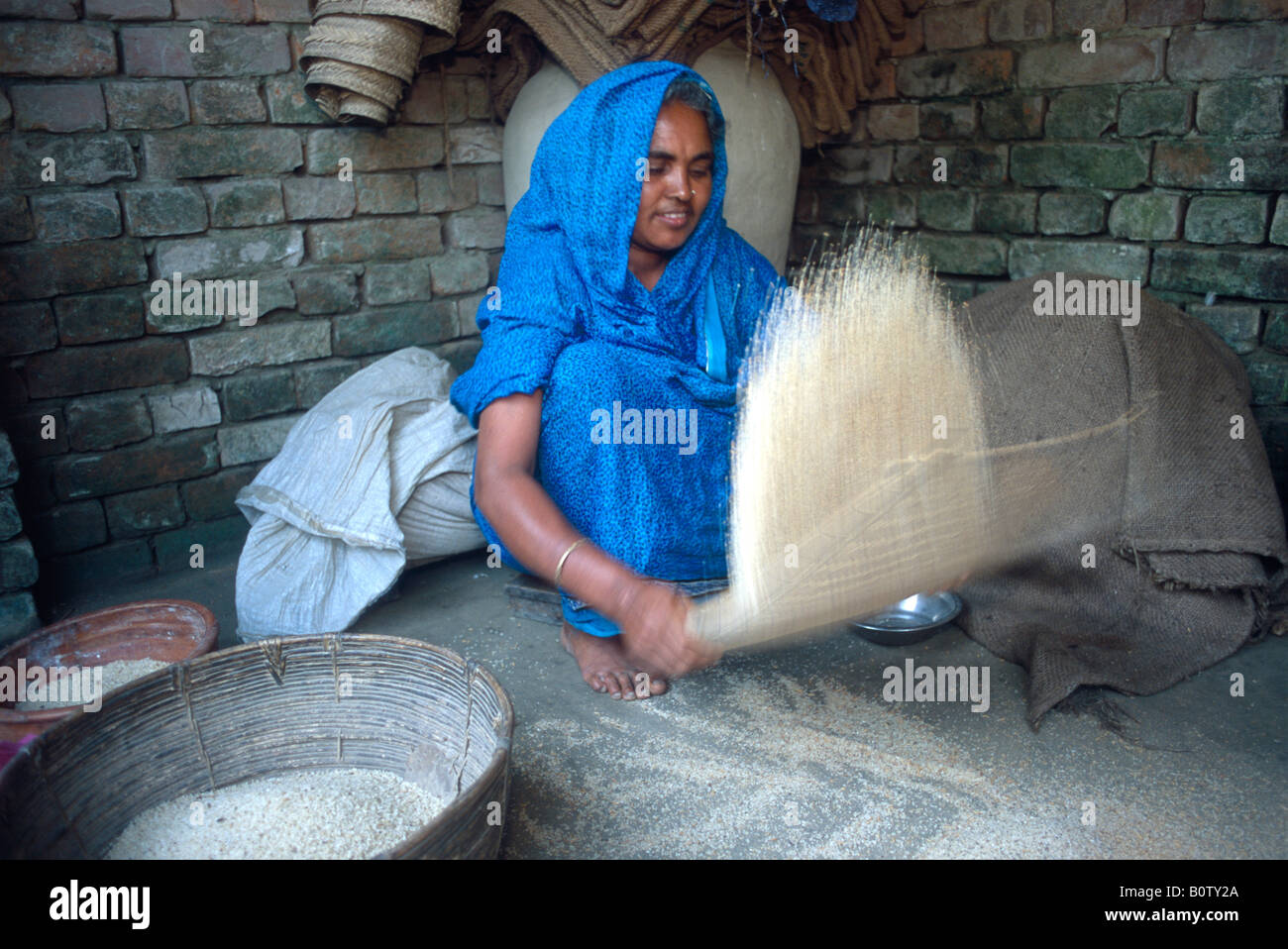 sifting rice for cooking Bangladesh Stock Photo - Alamy