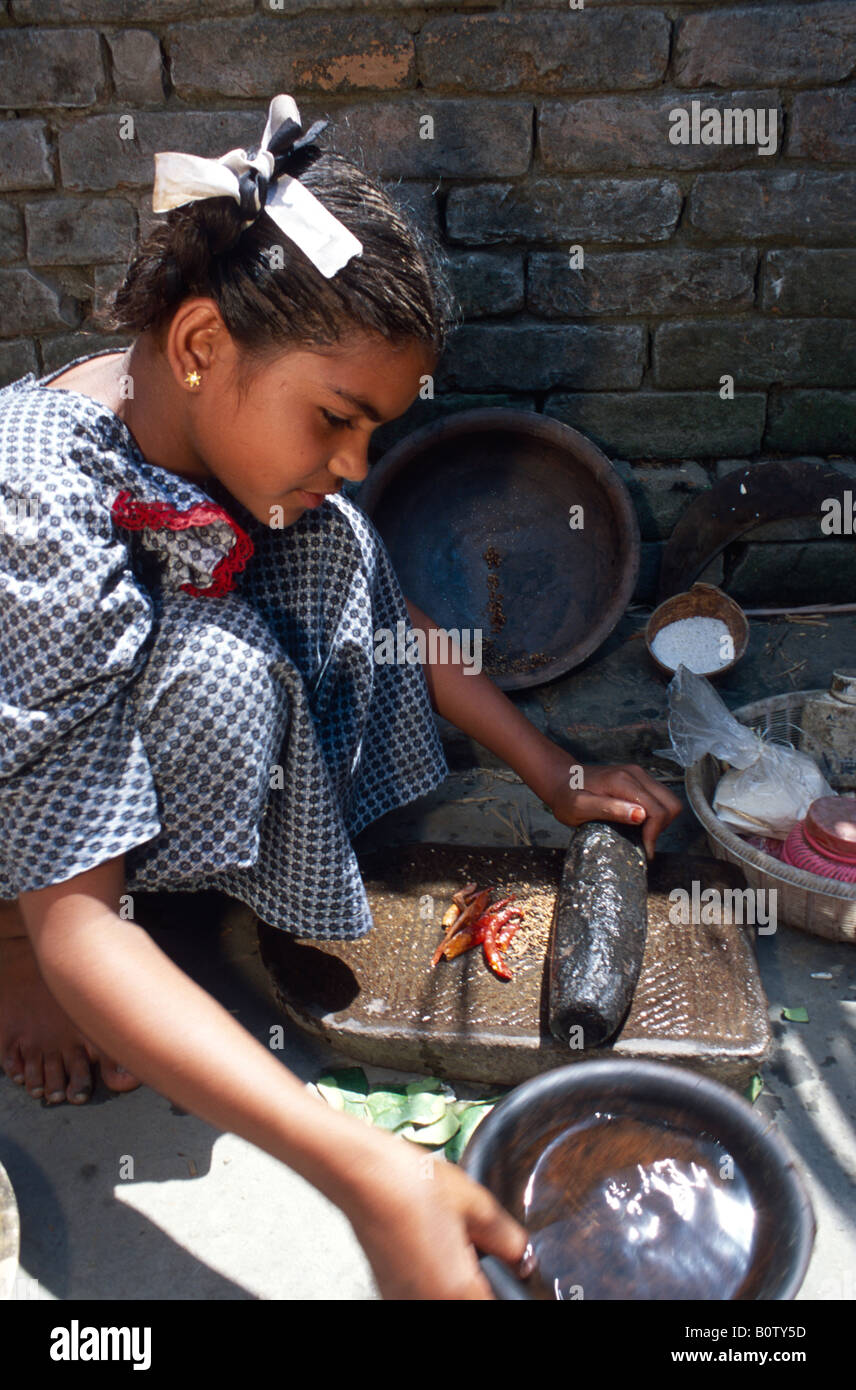 Grinding chilis to a paste for cooking Bangladesh Stock Photo - Alamy