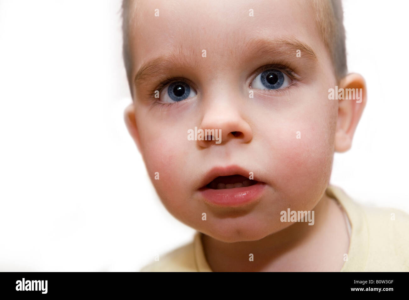 young boy: colour image off a young toddler boy face looking at the ...