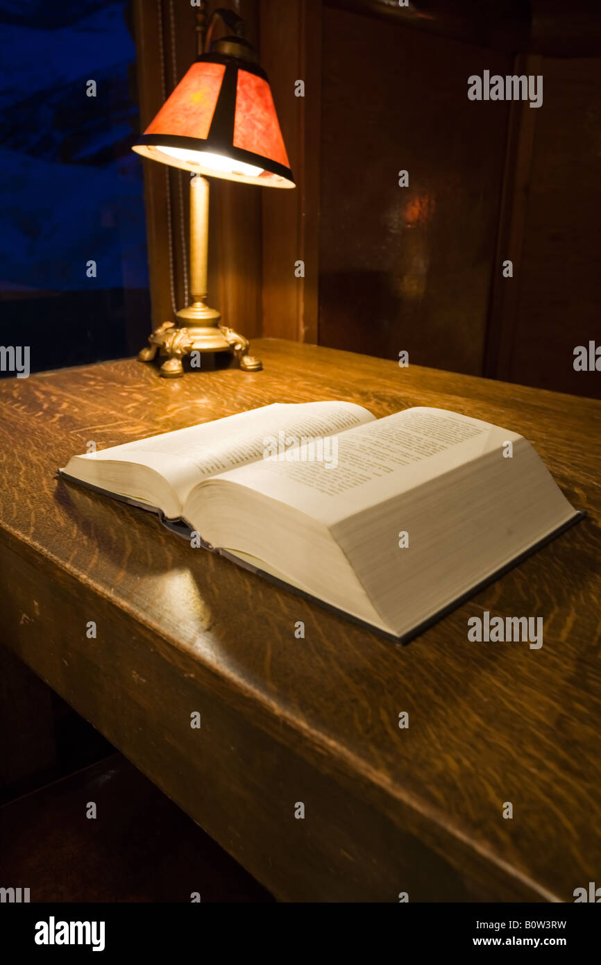 Open book and warm lamp on study table Stock Photo - Alamy
