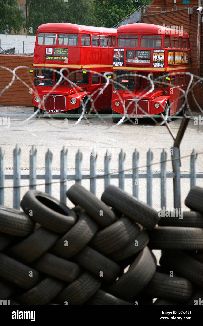 two routemaster buses in a depot in west london Stock Photo - Alamy