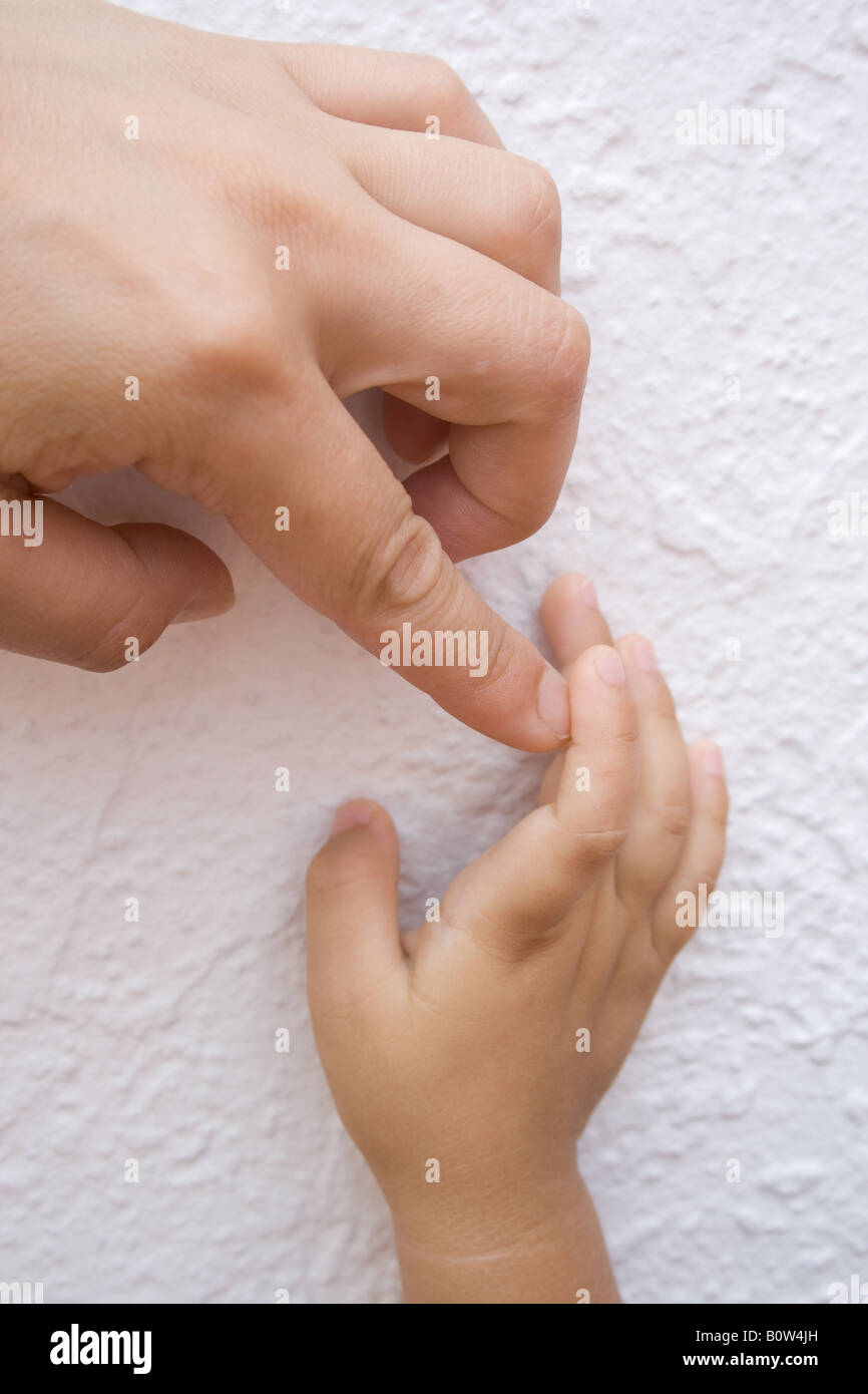 Mother's finger touching baby's finger Stock Photo - Alamy