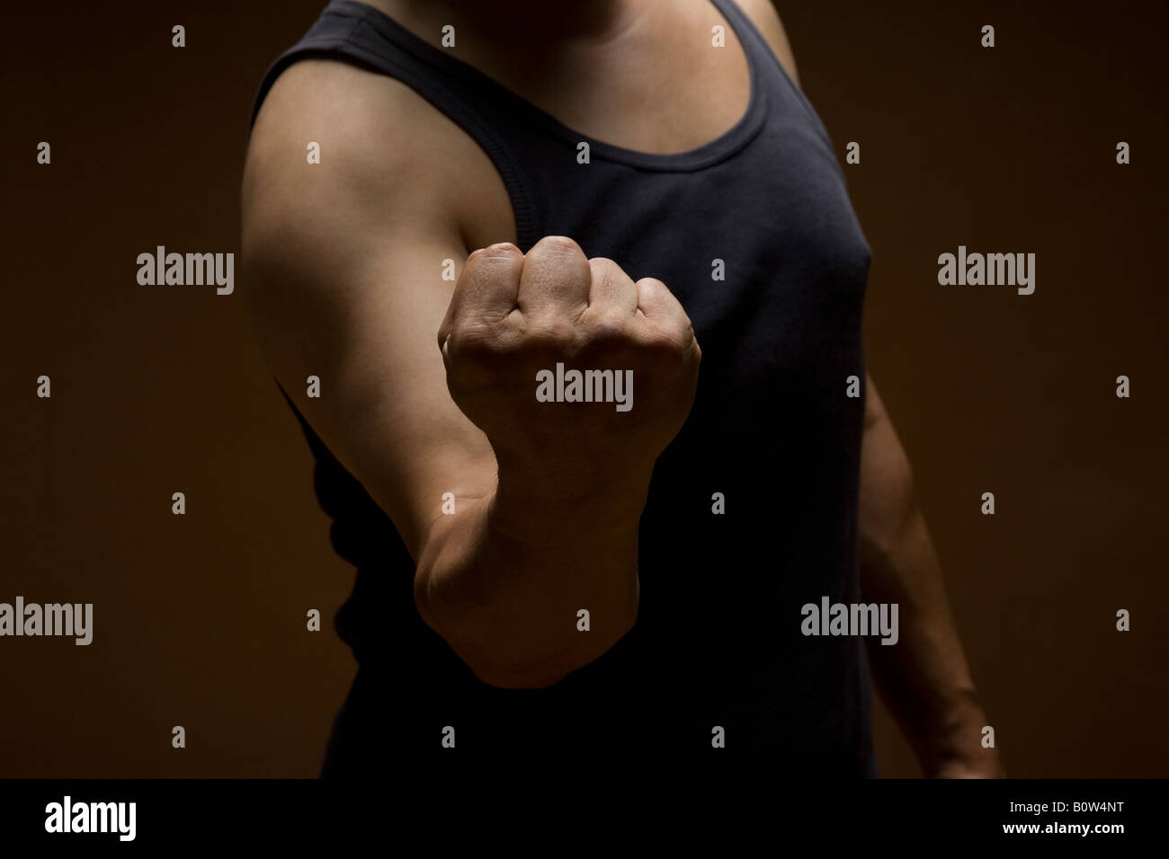 Muscular man clenching fist, midsection Stock Photo - Alamy