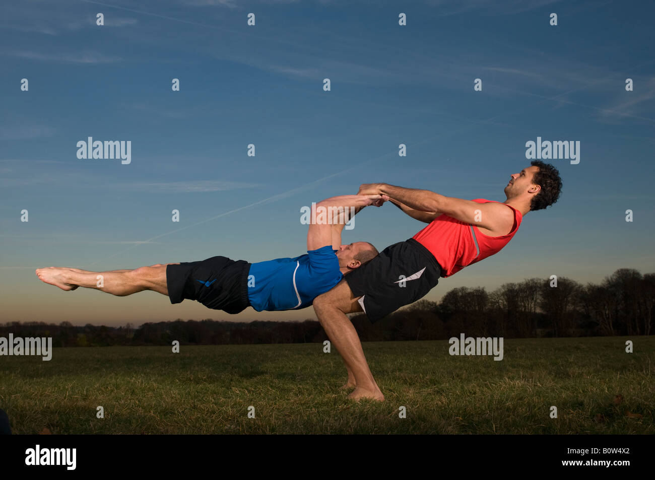 Two acrobats performing a static hold Stock Photo - Alamy