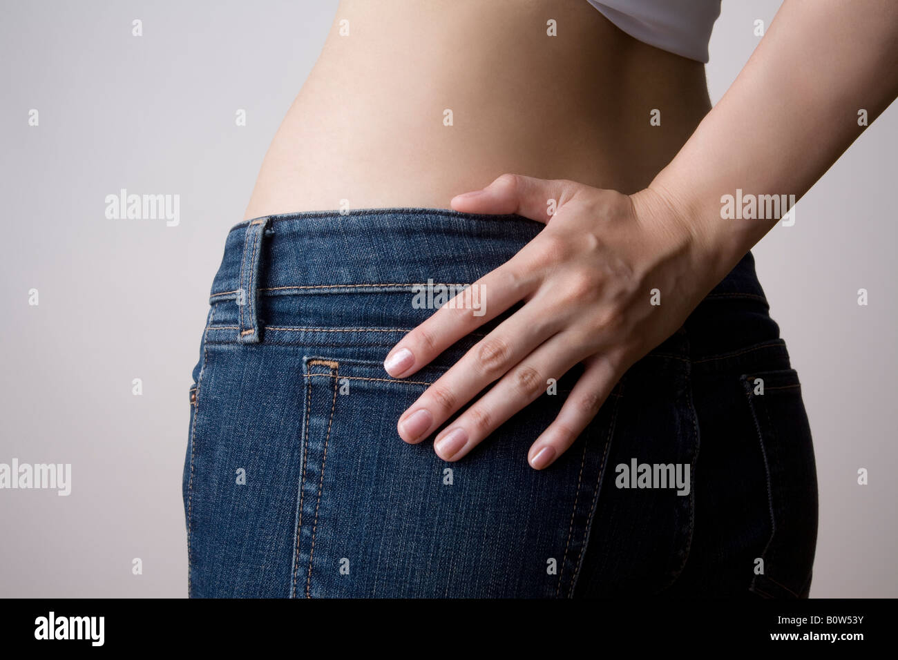 Woman standing with hand on hip, midsection Stock Photo - Alamy