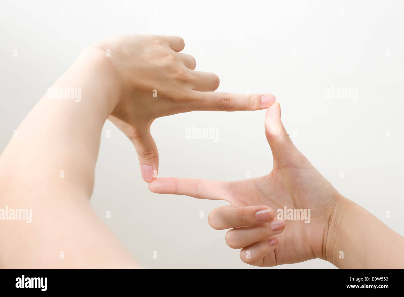 Woman making square shape with fingers Stock Photo - Alamy