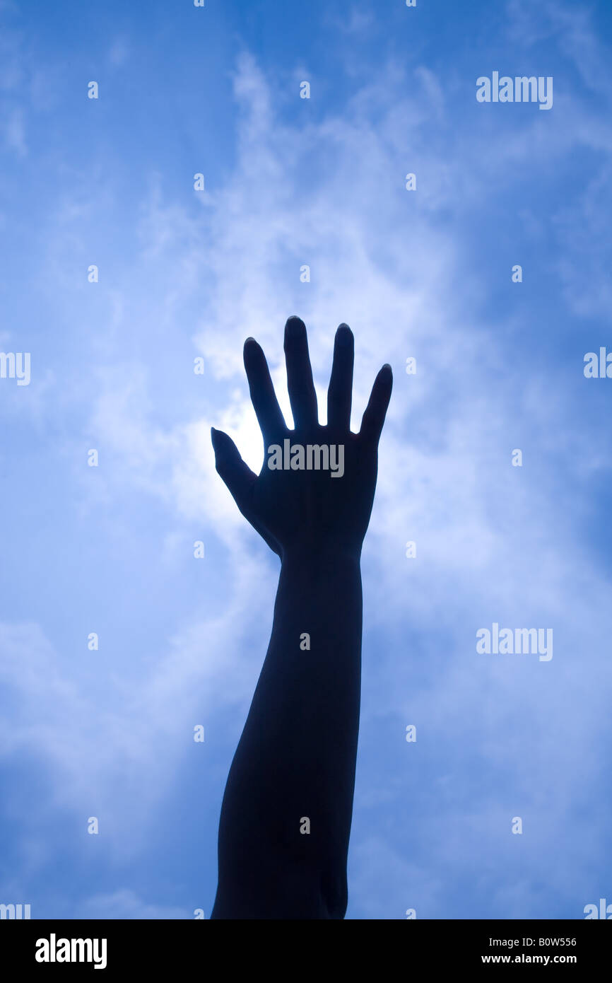 Woman's hand reaching for sky Stock Photo - Alamy