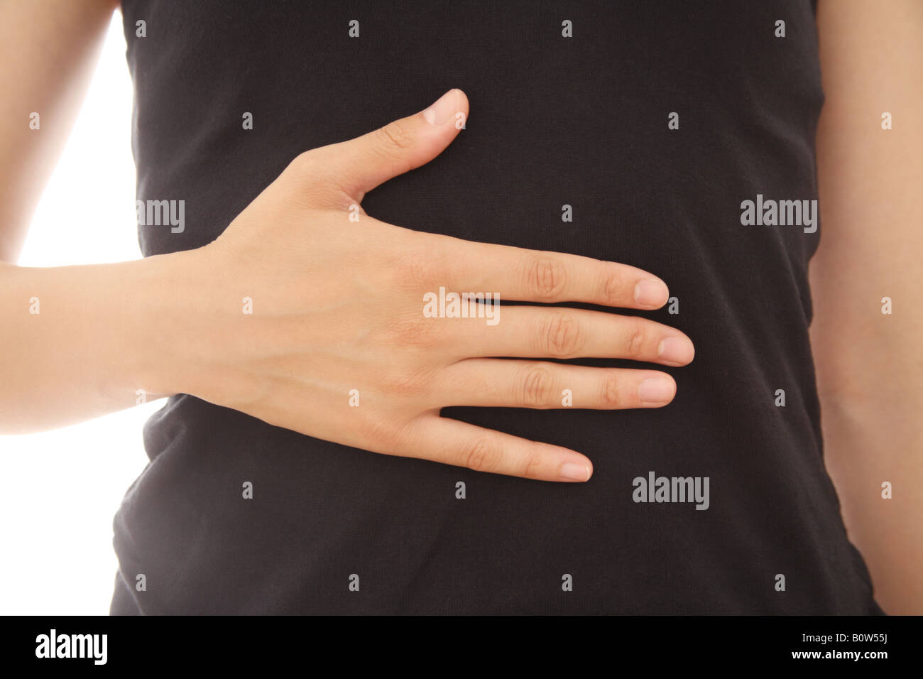 Woman with hand on her stomach, midsection Stock Photo - Alamy