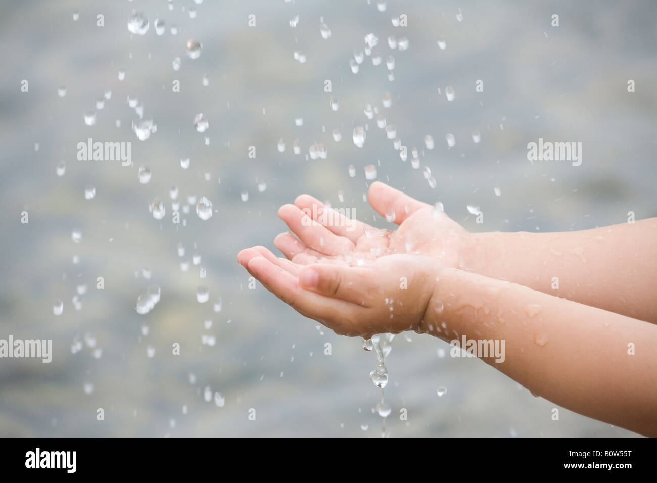 Child playing with water Stock Photo - Alamy