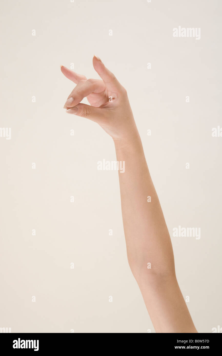 Woman making fox with fingers Stock Photo - Alamy