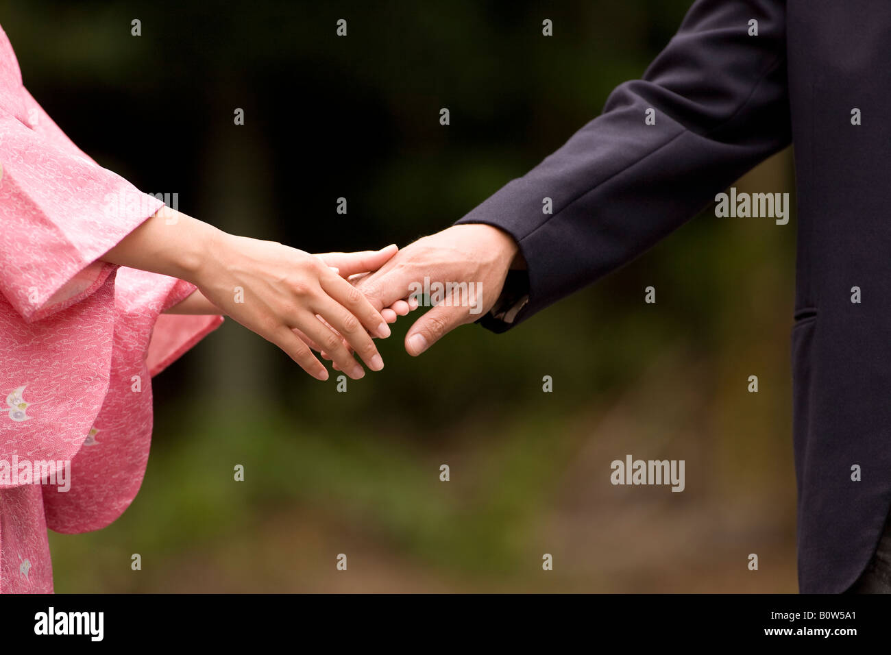 Woman taking man's hand Stock Photo - Alamy