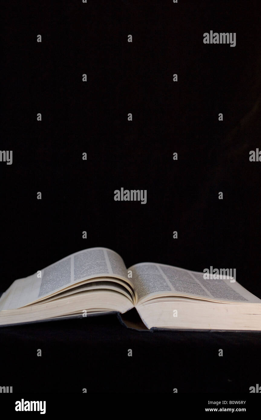 Open book on a black background Stock Photo - Alamy