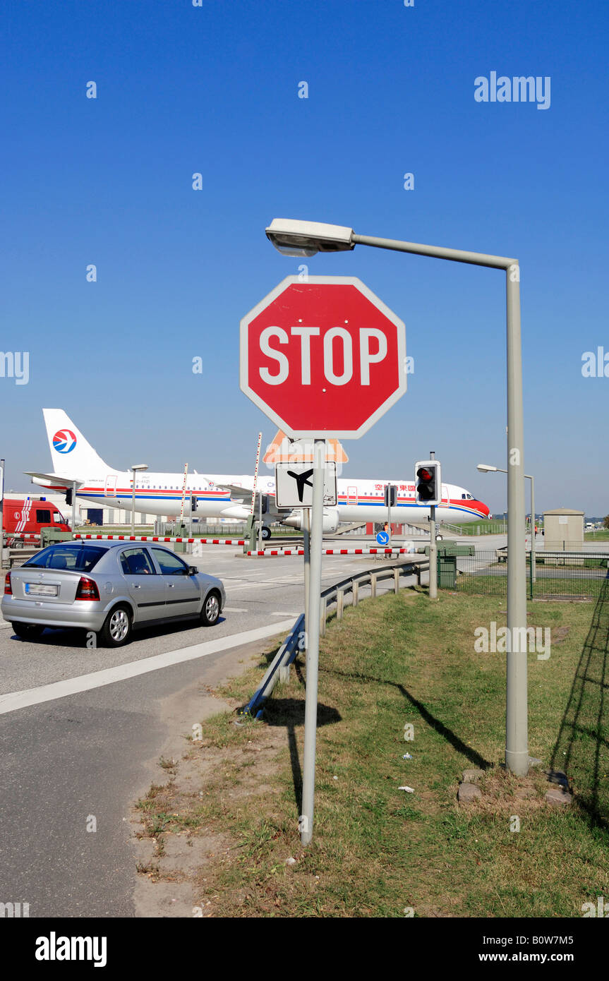 Airplane crossing over a road, Finkenwerder, Hamburg, Germany, Europe ...