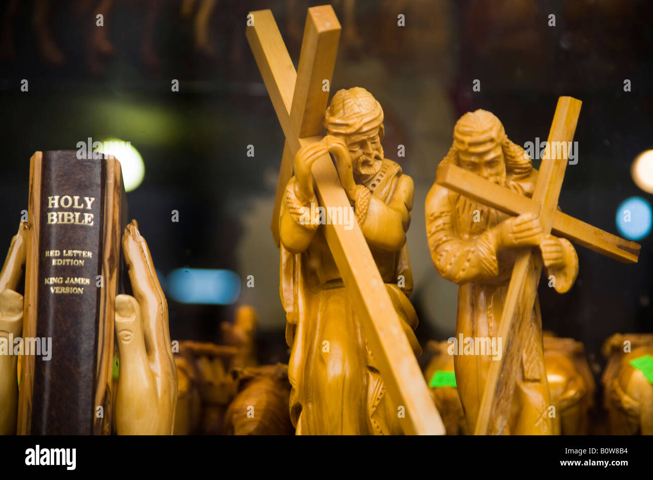Two carved wooden figures of Jesus carrying the cross and praying hands ...