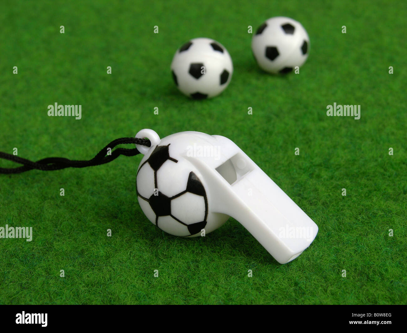 Miniature footballs, soccer balls, whistle on pitch Stock Photo - Alamy