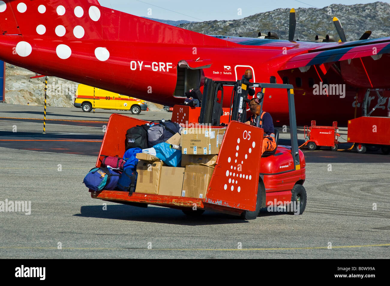 Fork lift, baggage transport vehicle unloading an airplane, Ilulissat ...