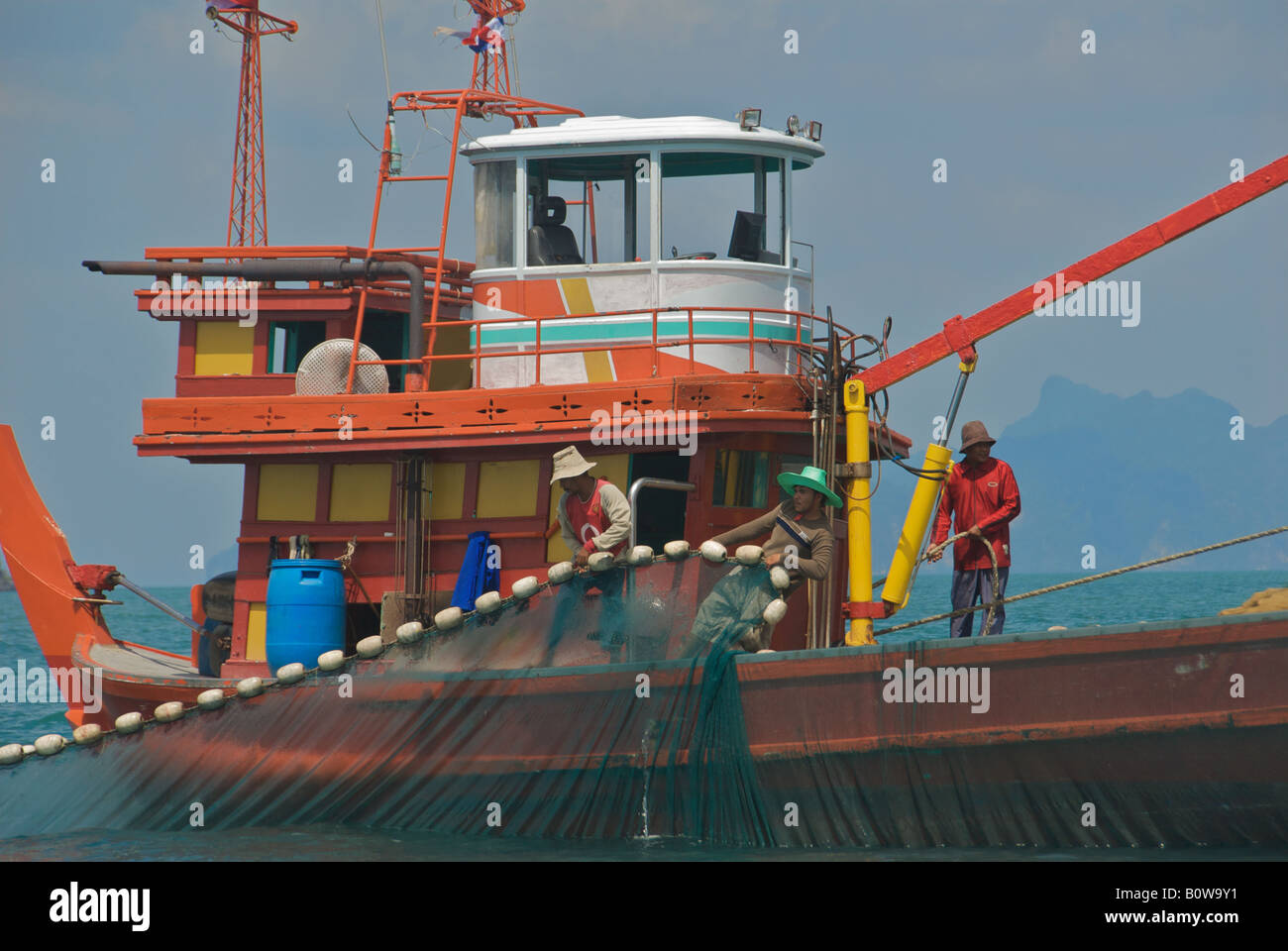 Hauling in the nets on trawler fishing boat Andaman Sea Krabi Province ...