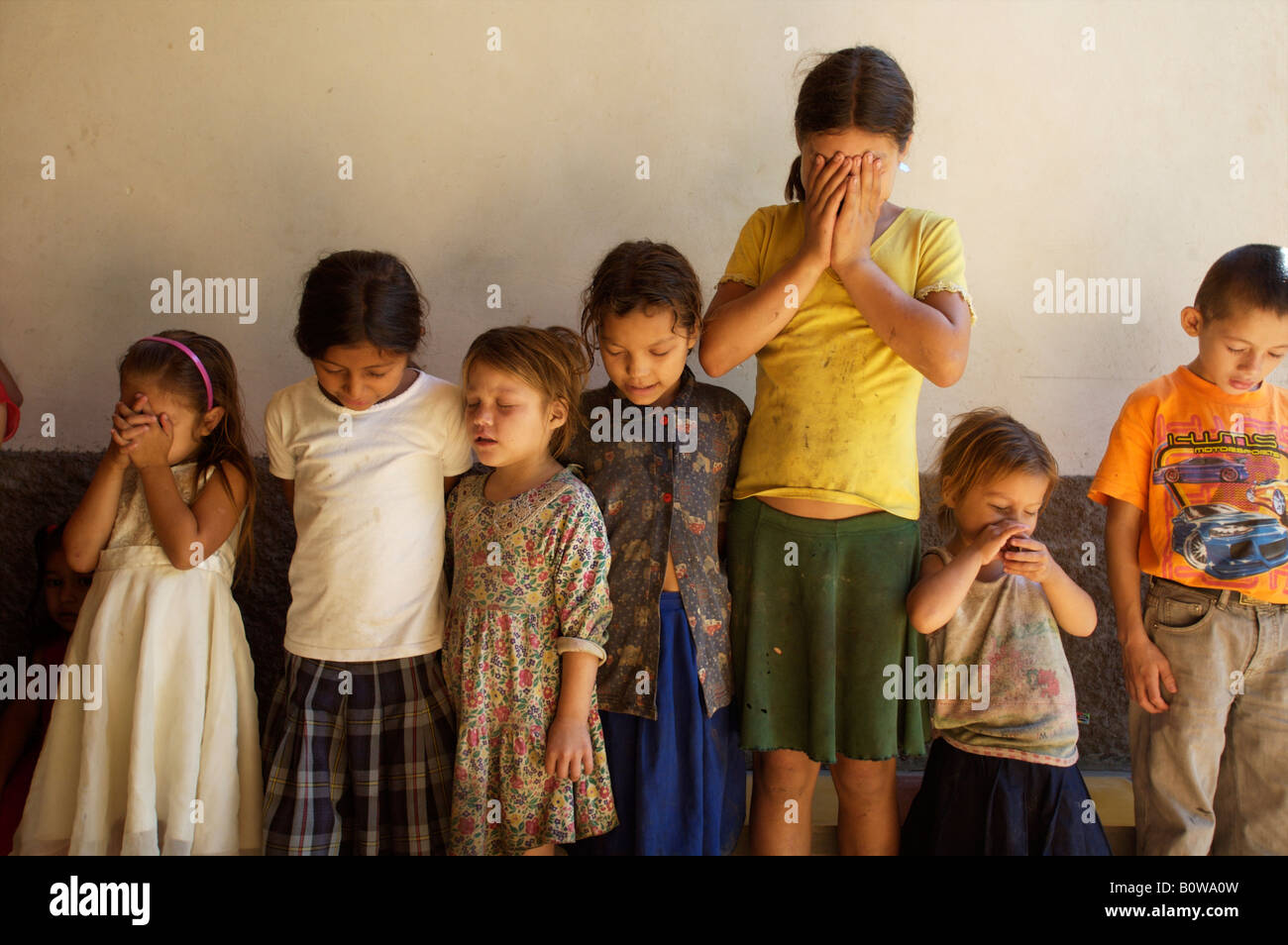 Children pray while attending Sunday school put on by baptist ...