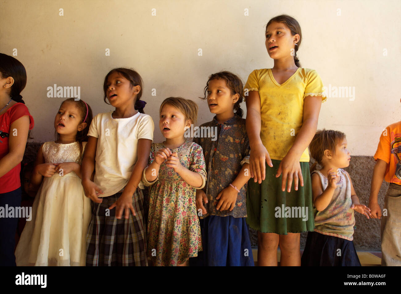 Children pray while attending Sunday school put on by baptist ...
