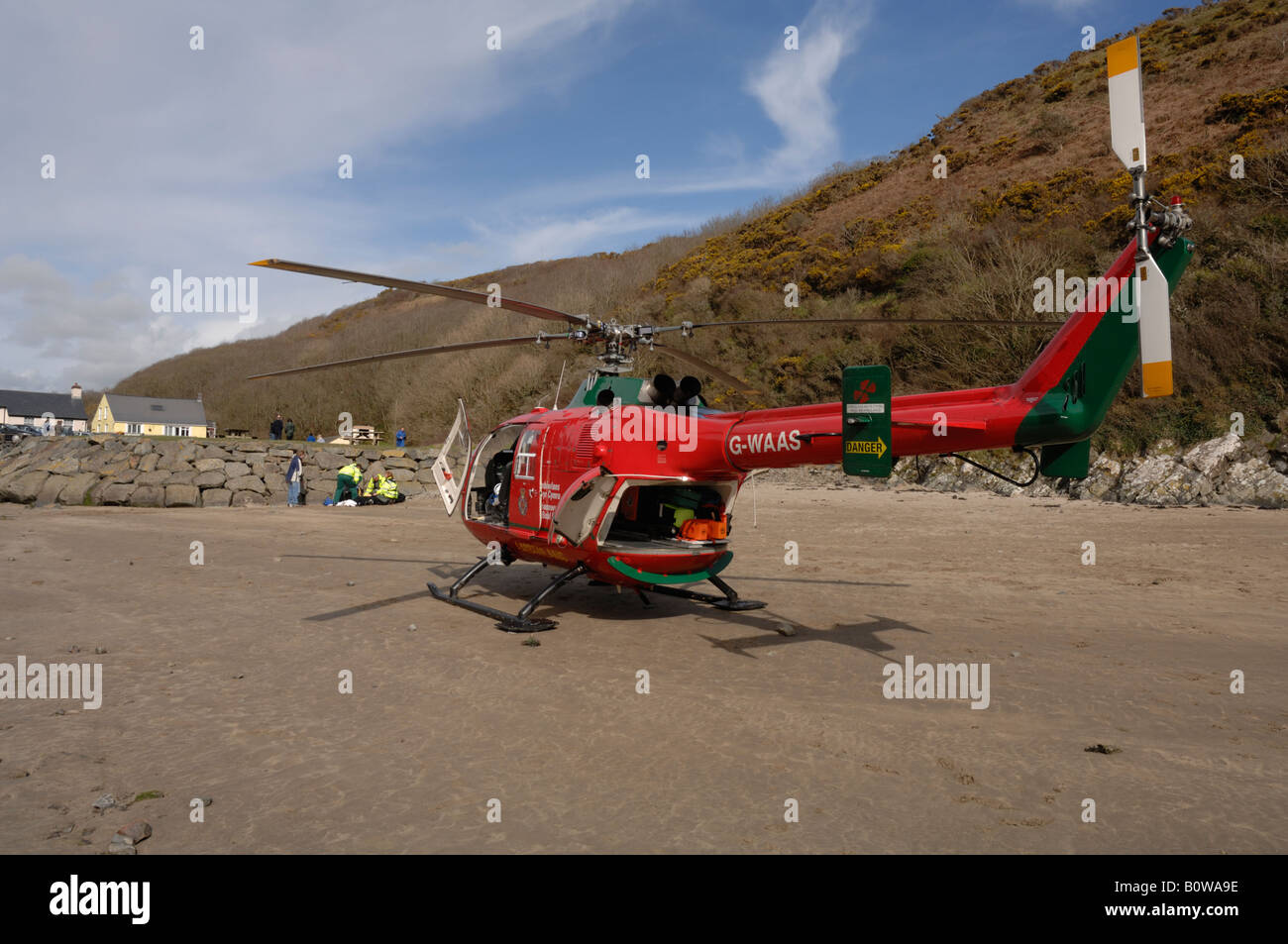 Wales Air Ambulance helicopter and crew rescuing a casualty at Solva ...