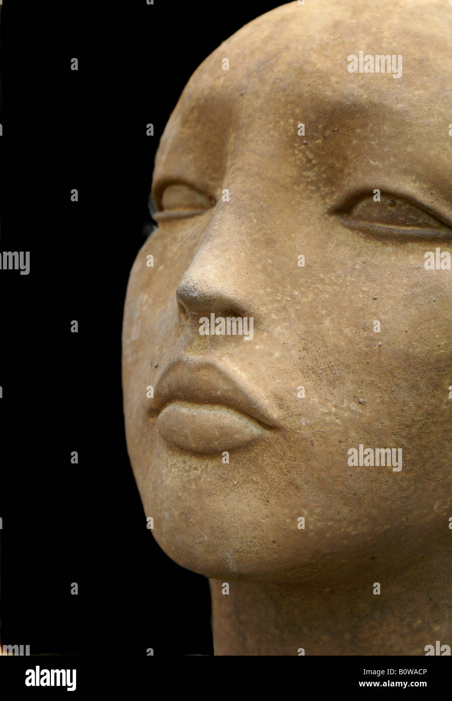 isolated closeup of clay figurine face depicting mouth nose eye sockets ...