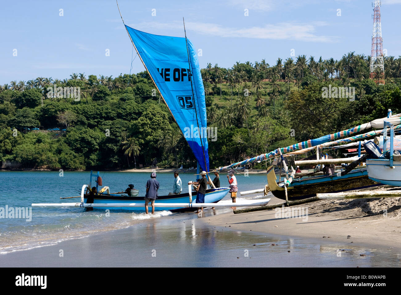 Fisherman returning to shore from fishing with the sail open on his ...
