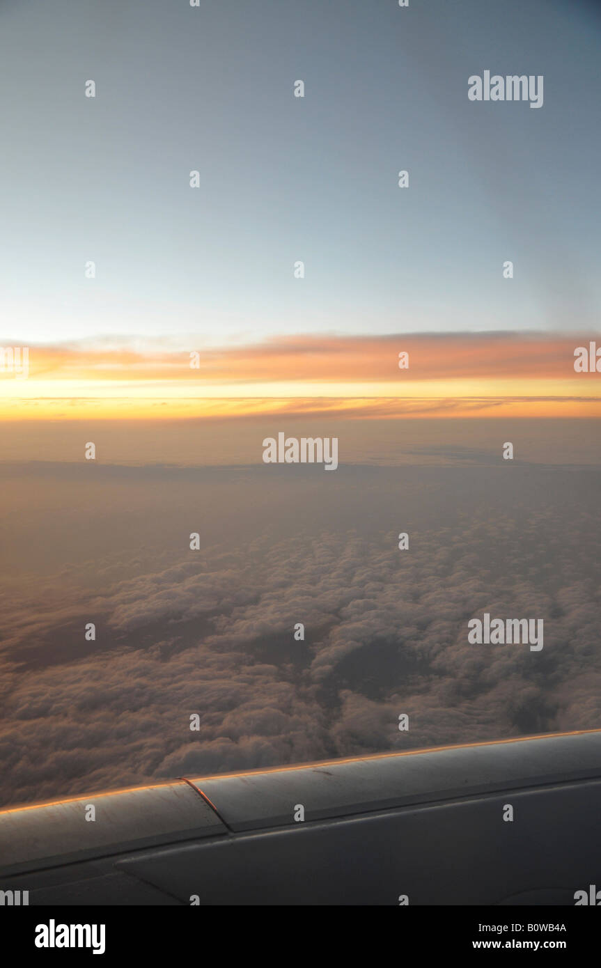 Sunset, view from an airplane window, wing, clouds Stock Photo - Alamy