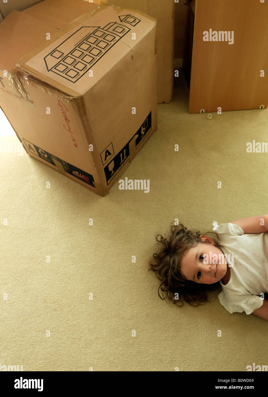 Packing Boxes and Small Girl Stock Photo - Alamy