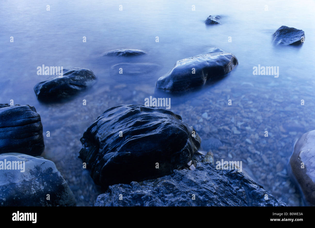 Stones in a lake Stock Photo - Alamy
