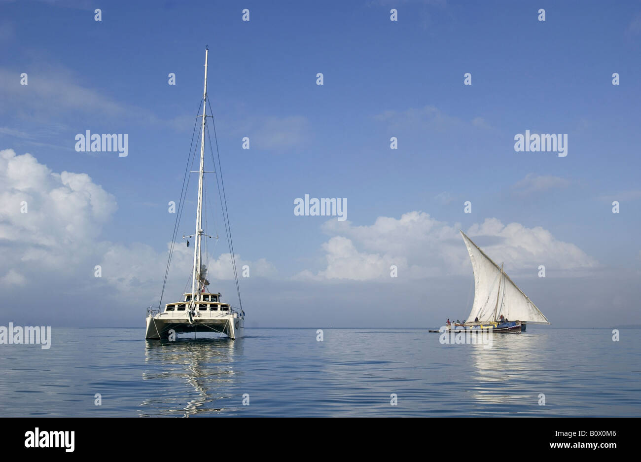 Modern yacht & traditional Dhow Stock Photo - Alamy
