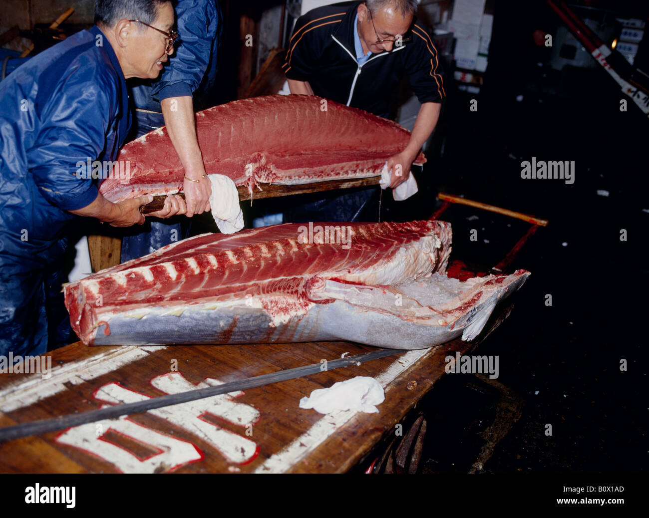 Men cutting tuna Stock Photo - Alamy