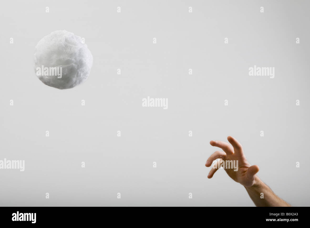 A human hand throwing a large cotton ball Stock Photo - Alamy