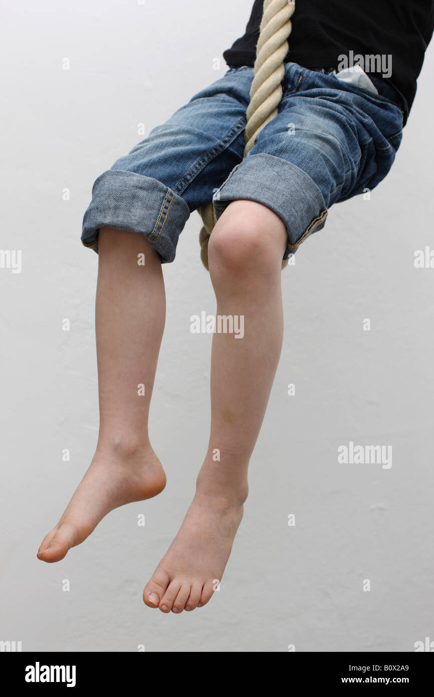 A child sitting on a rope swing Stock Photo - Alamy