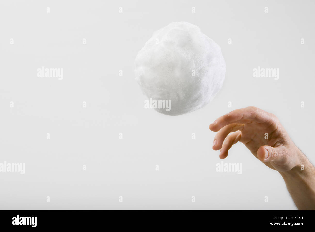 A human hand throwing a large cotton ball Stock Photo - Alamy